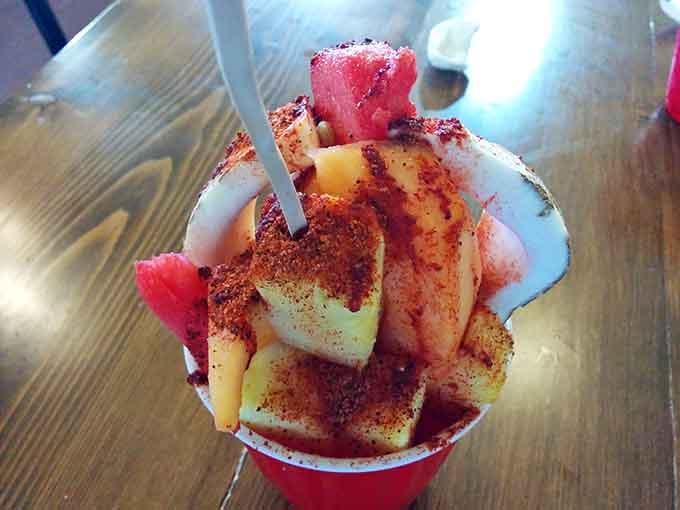 Fresh fruit raspado topped with chamoy and chili powder. Sweet, spicy, cold refreshment in a cup of joy.