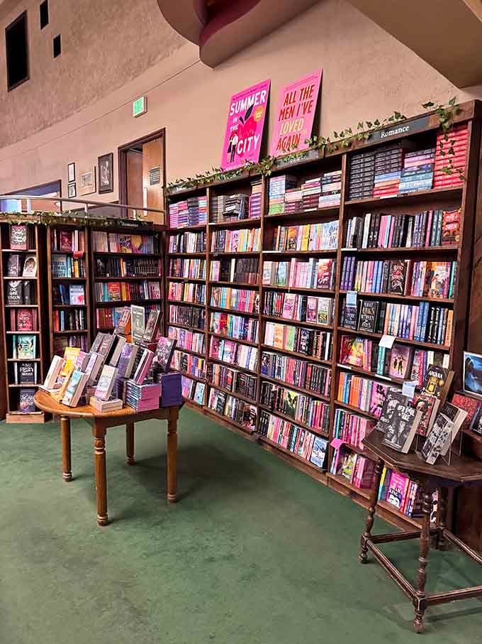 Floor-to-ceiling shelves showcase romance titles in every shade imaginable, organized better than most people's sock drawers could ever be.