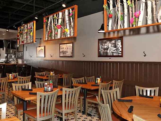 Birch branches and warm lighting create an atmosphere that's both modern and welcoming for a relaxed dining experience.