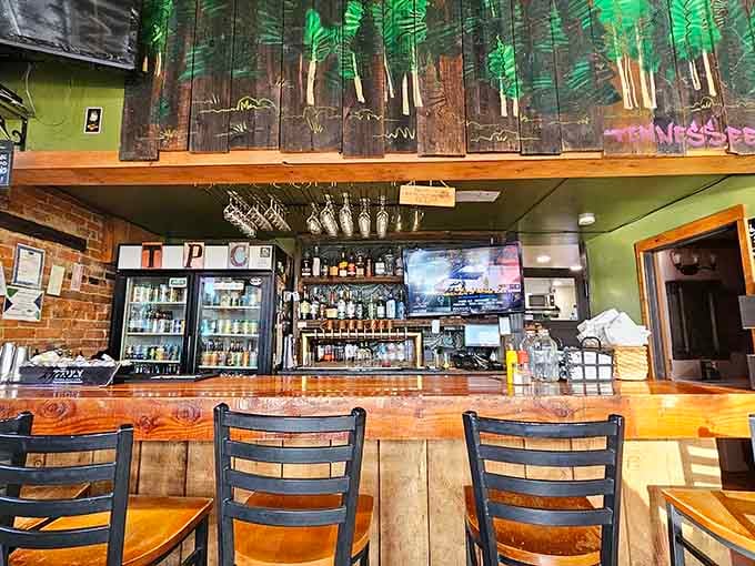 Exposed brick and forest murals behind the bar blend rustic charm with artistic flair throughout the space.