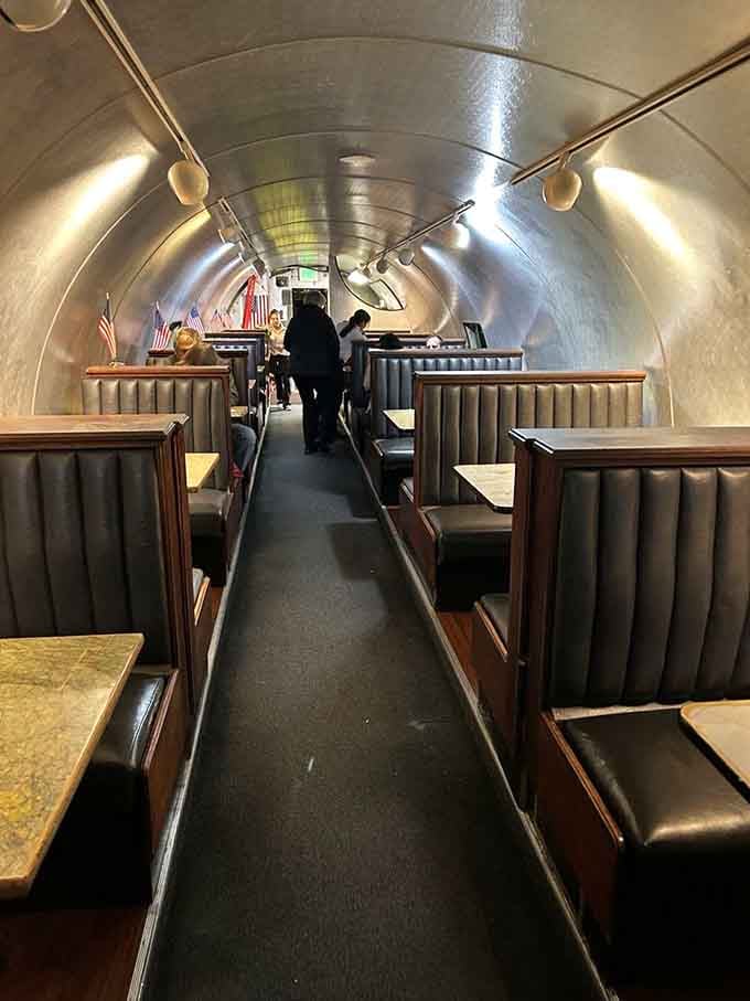The curved fuselage ceiling and booth seating create an intimate dining experience that commercial airlines stopped offering decades ago.