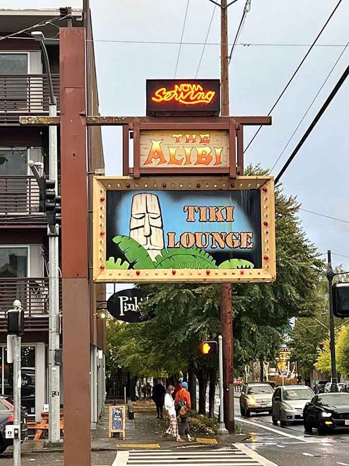 A vertical sign that announces "Tiki Lounge" like it's the best news you'll hear all week, honestly.