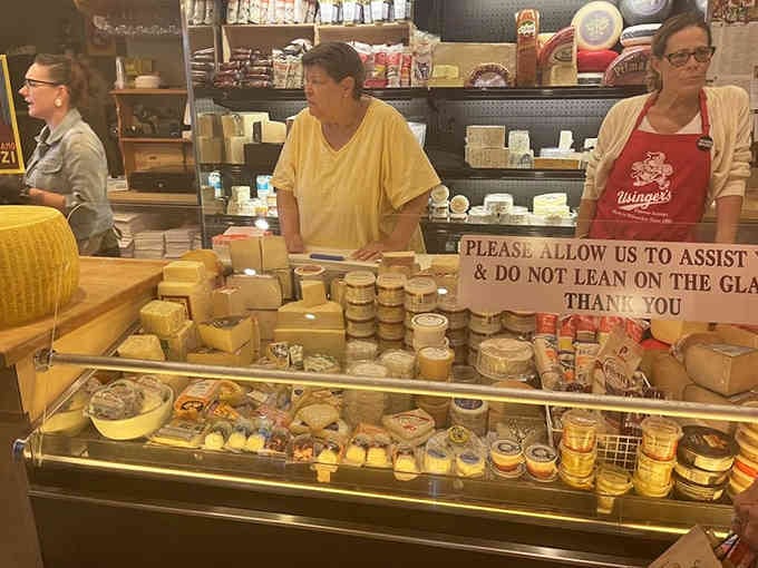 The friendly staff behind the counter, ready to craft your perfect sandwich with practiced precision and genuine smiles.