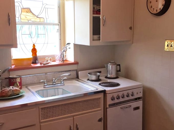 The kitchen features period-appropriate appliances and a window that reminds you you're inside a shoe.