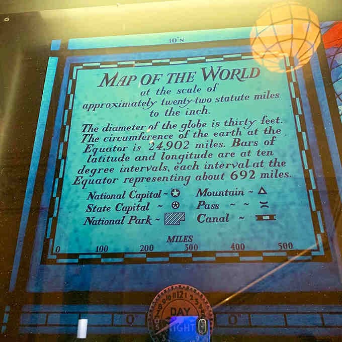 The informational plaque reveals the globe's impressive scale: thirty feet of stained glass representing our entire planet in miniature.