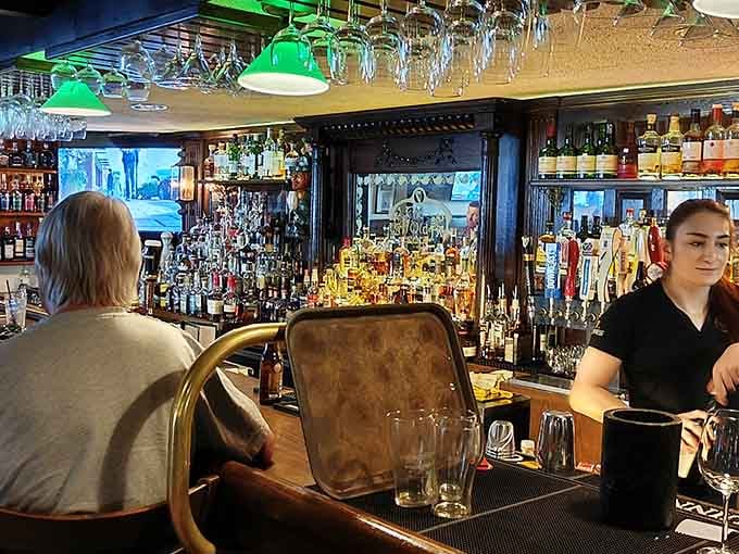 The bar gleams with bottles standing at attention while friendly staff work their magic behind polished wood counters.