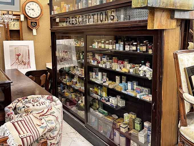 The old pharmacy cabinet stands as a museum piece, its "PRESCRIPTIONS" sign a relic from when medicine came in amber bottles.