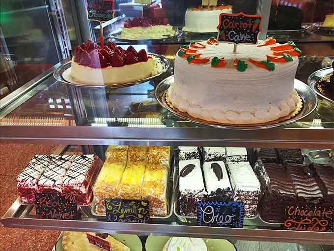 The dessert case displays towering cakes that make choosing just one slice feel like an impossible decision.
