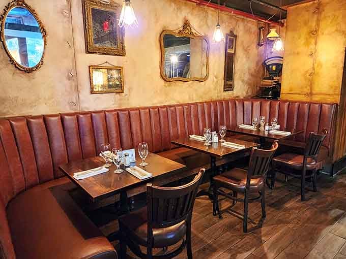 Ornate mirrors reflect candlelight across weathered walls, adding romance to a space that once stored cold hard cash.