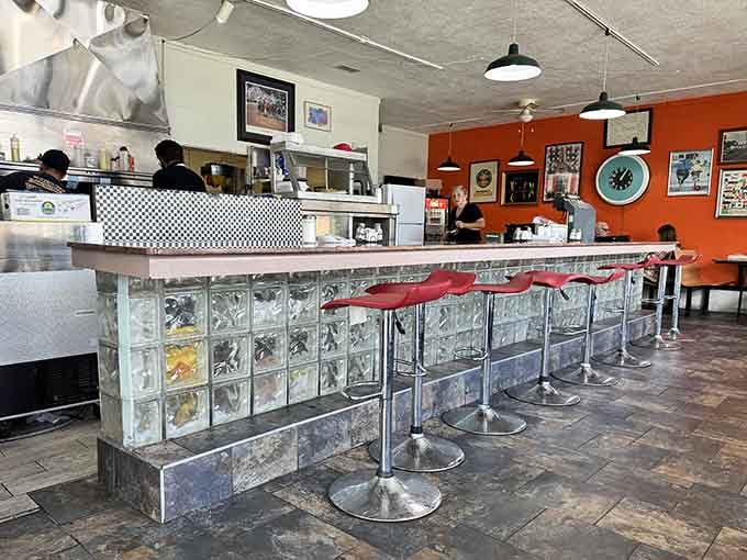 Counter seating with red stools gives you front-row seats to watch the kitchen magic happen in real-time.