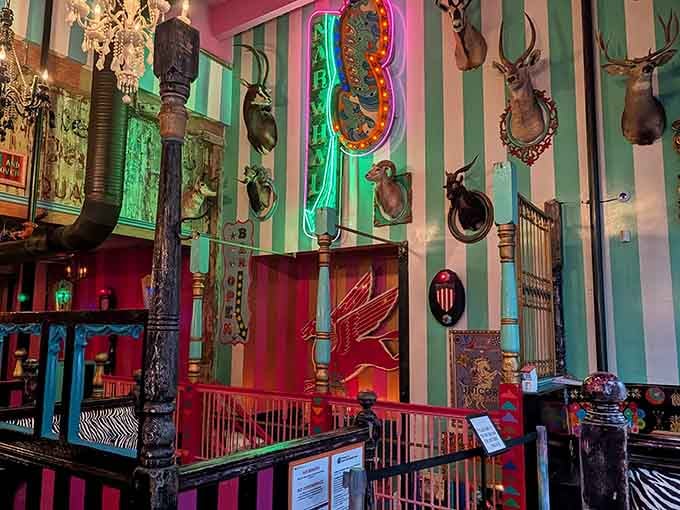 Striped walls and mounted animal heads create an aesthetic that's equal parts hunting lodge and circus tent.