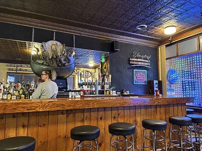 The bar area features decorative tin ceiling tiles and enough beer taps to make any decision delightfully difficult.