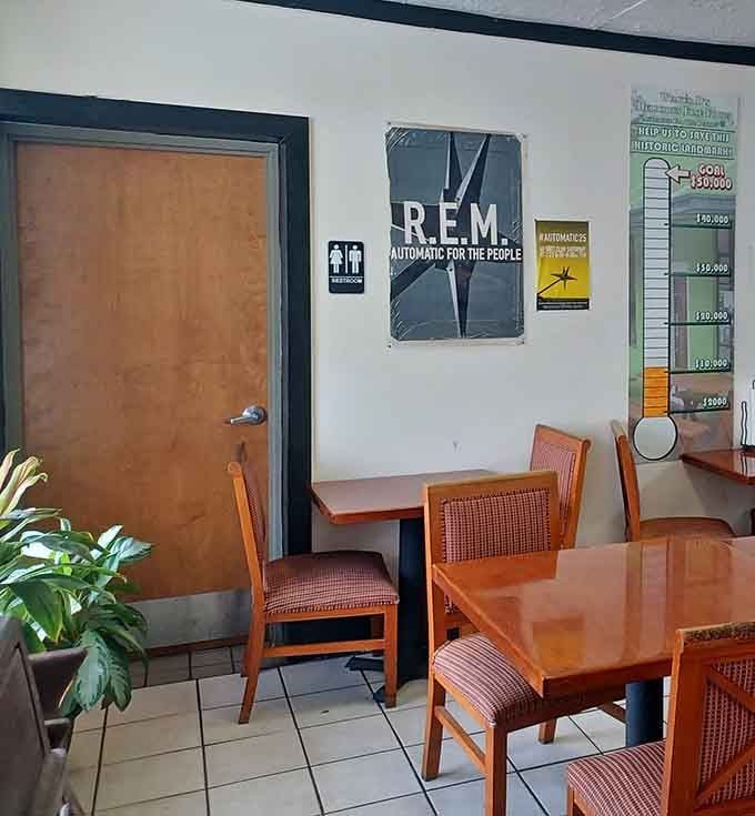 Simple dining space with an R.E.M. poster reminding you this place inspired actual rock history.