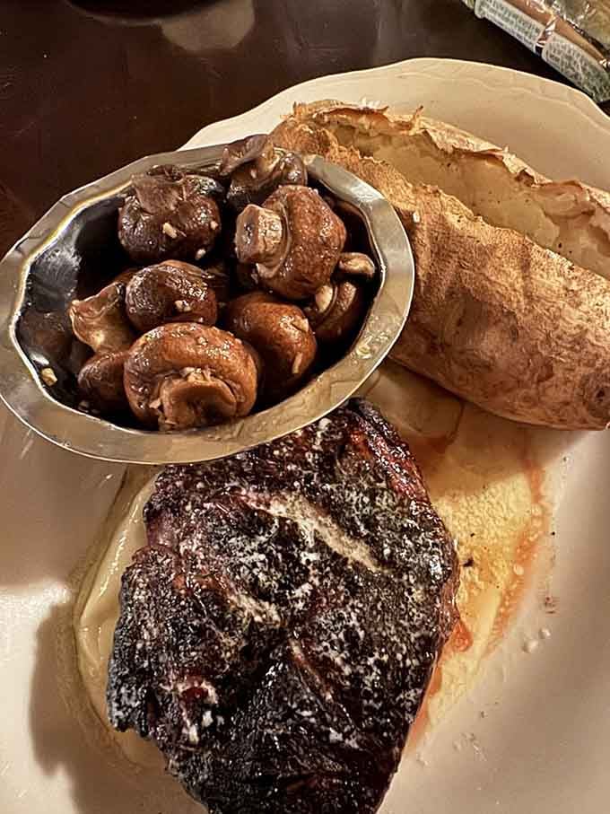 That perfectly cooked filet with saut&eacute;ed mushrooms is basically a love letter written in beef and butter, signed with charcoal smoke.