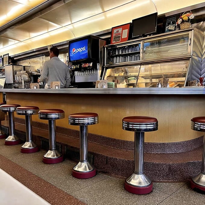 The counter seats offer front-row tickets to the breakfast theater, where griddle masters perform their morning symphony.
