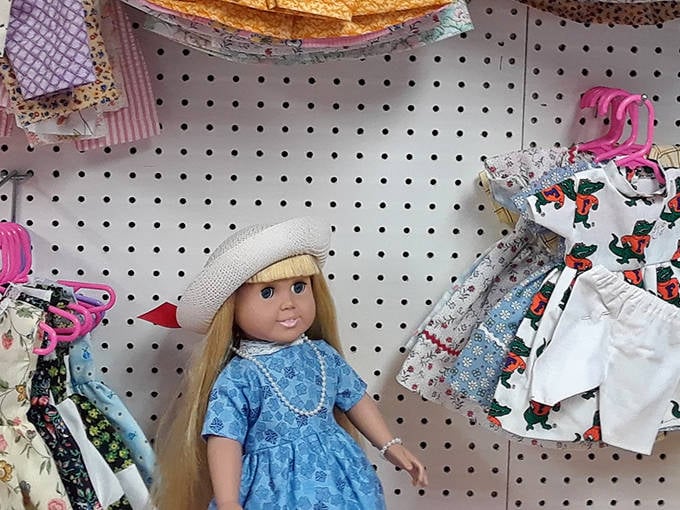 Dolls with stories to tell line the pegboard walls. That blue-dressed beauty might become someone's cherished childhood companion.