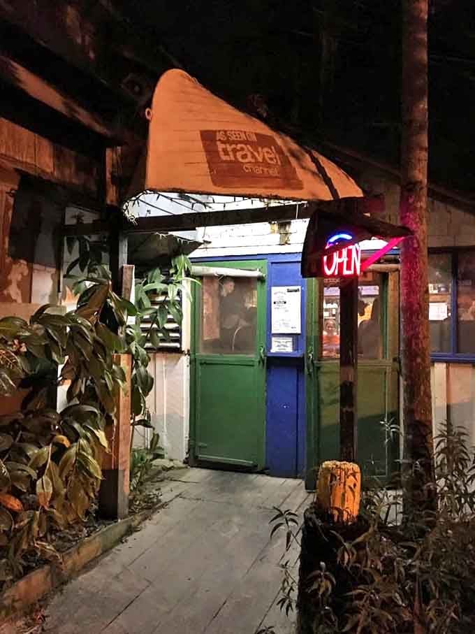 This entrance might not look like much, but it's a portal to one of Tampa's most authentic experiences. The neon "OPEN" sign is your invitation to adventure.