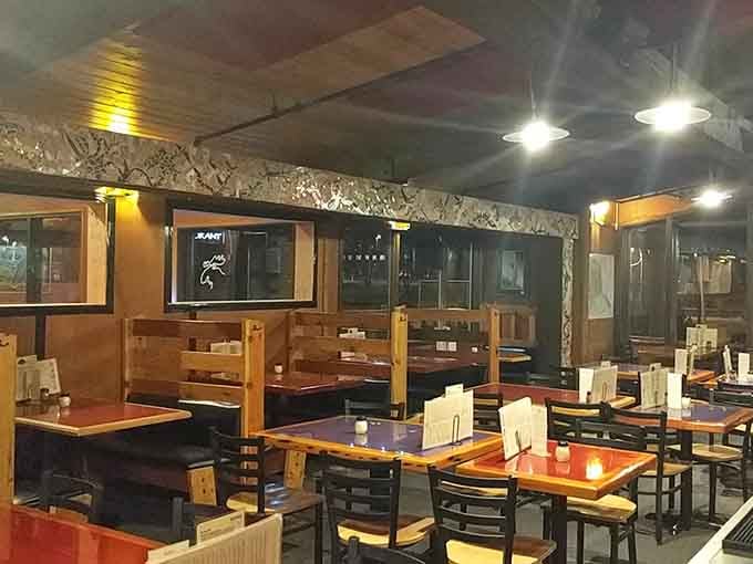 Evening light filters through windows, casting a golden glow on wooden booths where countless Alaskans have debated the merits of one more slice.