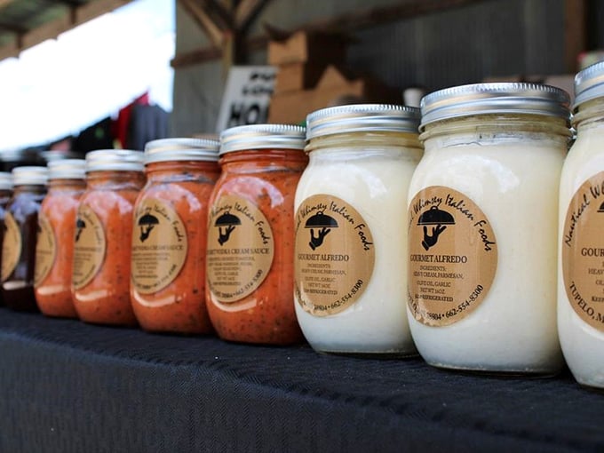 Mason jar magic—homemade sauces lined up like soldiers ready to transform your Tuesday night spaghetti from bland to grand.