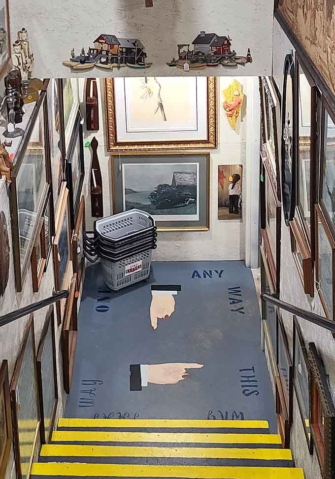 The stairway guides you with whimsical painted directions, proving that even navigation becomes an art form at 1A Relics.