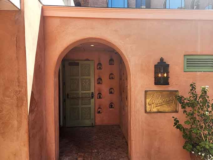 Peachy adobe walls and an arched doorway invite you into a Mediterranean escape tucked away from the bustle.
