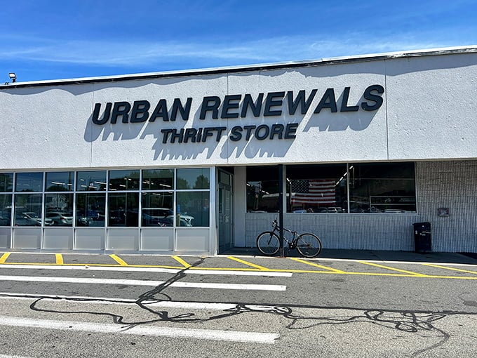 The bold black lettering against white walls gives this warehouse-style thrift store a modern, no-nonsense vibe that works.