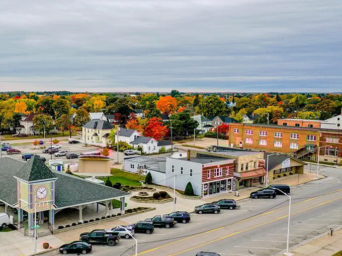 Fall foliage explodes around the clock tower, turning this small-town scene into a calendar-worthy autumn masterpiece.