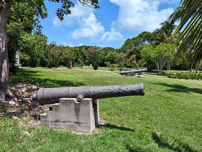 An antique cannon rests peacefully on manicured lawn, reminding visitors that even turbulent history eventually finds its peace.