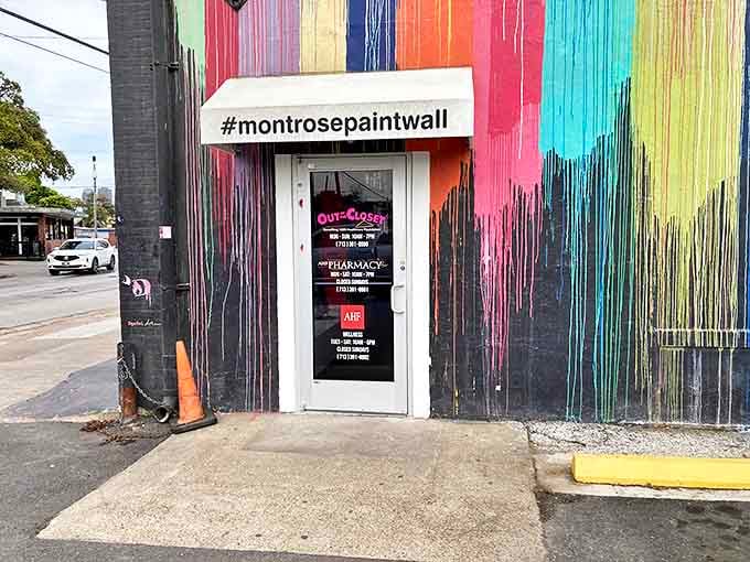 That rainbow paint wall transforms a simple entrance into Instagram-worthy art, proving thrift stores can be both practical and fabulous.