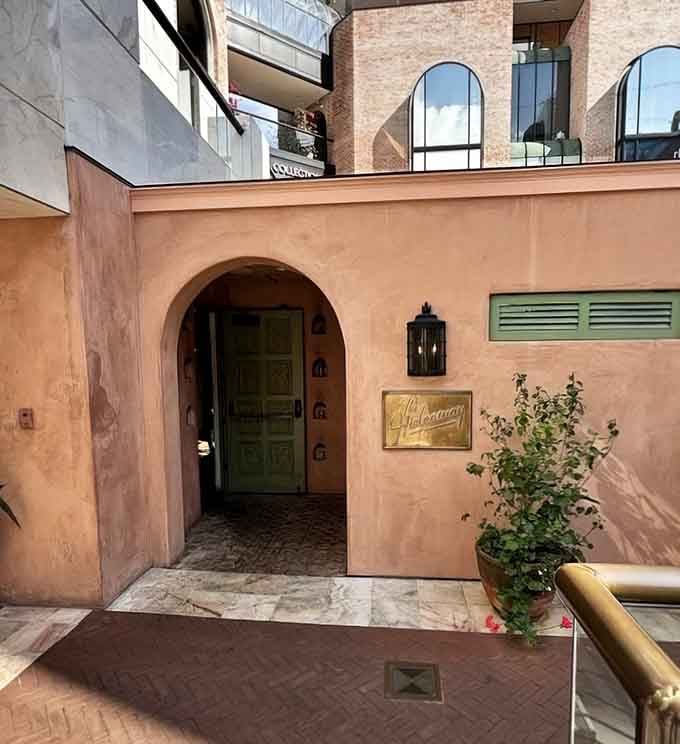 Sunlight dances on terracotta walls while that welcoming arch whispers secrets of the hidden treasures within.