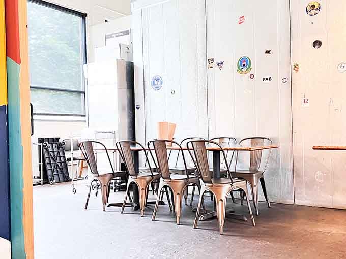 Metal chairs and chalkboard menus create that perfect casual vibe where sauce on your shirt is practically encouraged.