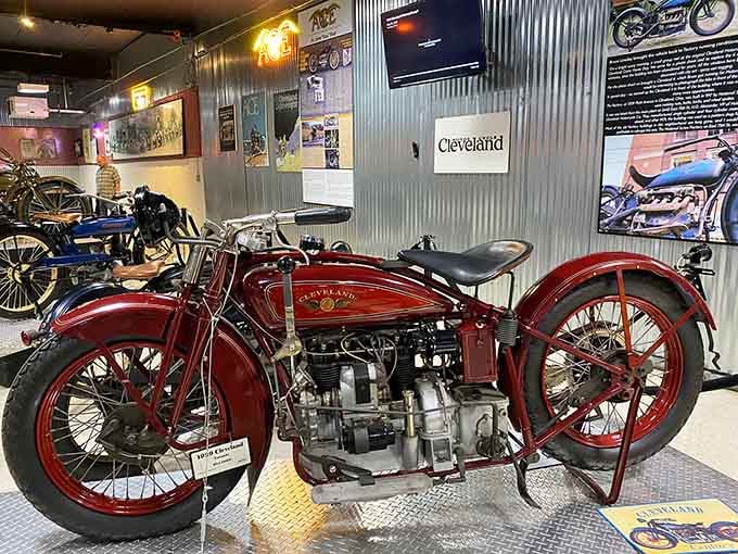 The 1929 Cleveland motorcycle gleams in deep red, proving American craftsmanship was already world-class a century ago.