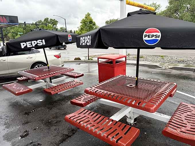 Red picnic tables under Pepsi umbrellas, the classic American drive-in setup that never goes out of style.