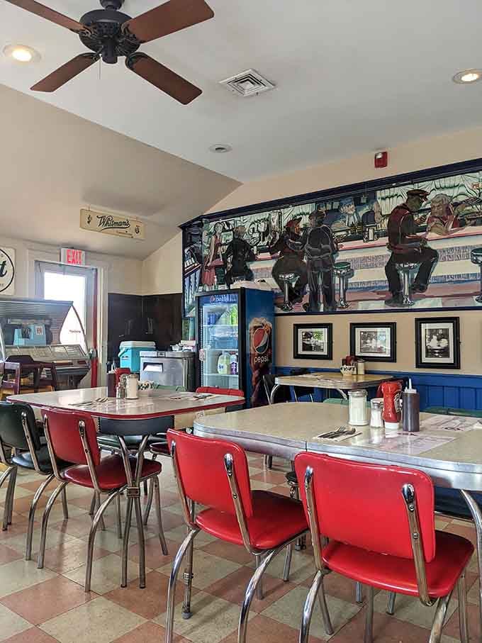 Red chairs lined up like soldiers ready to support your breakfast mission, with tables shiny enough to check your reflection.