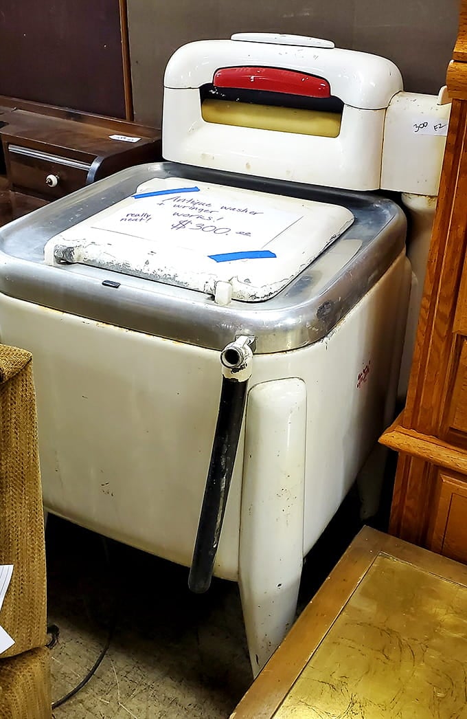 A vintage washing machine that's seen more laundry cycles than most of us have seen birthdays, still standing proud.