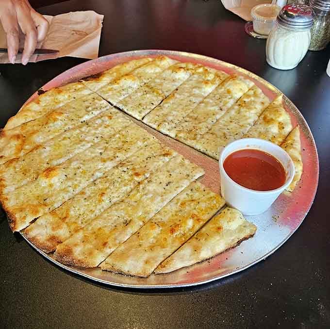 That cheese bread stretches across the platter like a delicious blanket begging to be devoured immediately.