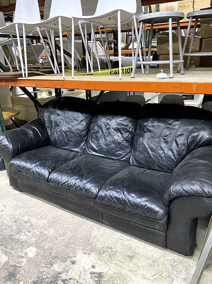 This well-loved leather couch has absorbed countless conversations, naps, and probably a spilled drink or two&mdash;character you can't buy new.