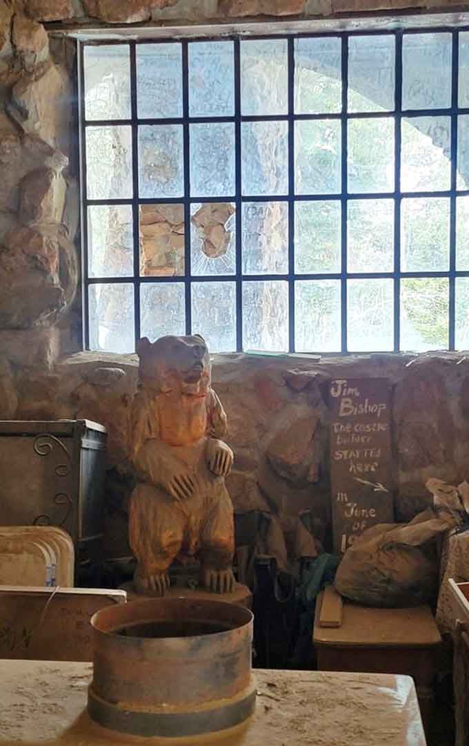 Hand-carved bear sculpture watching over the castle like a furry security guard who never takes coffee breaks.