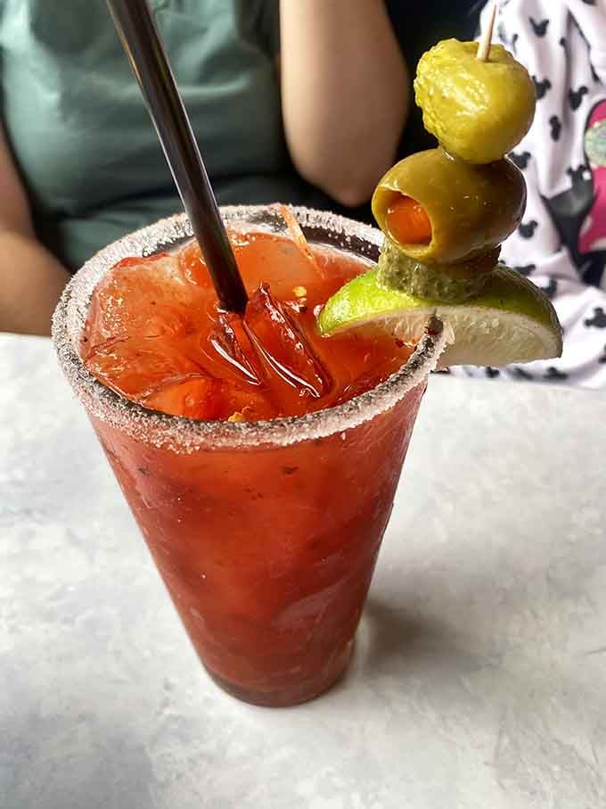 A Bloody Mary garnished like it's ready for its close-up, because brunch deserves a little drama too.