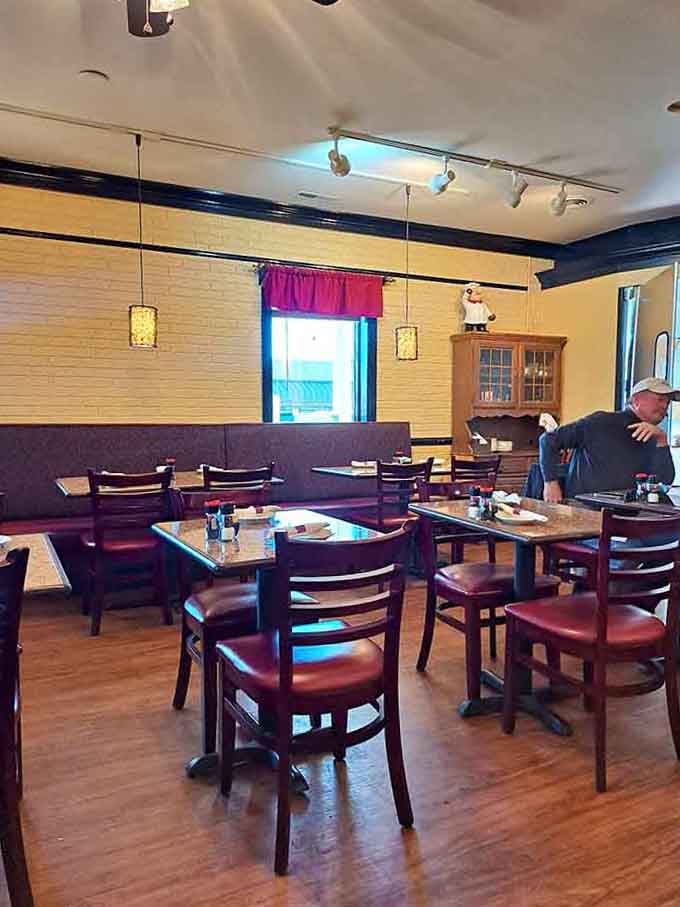 A cozy neighborhood spot where wooden chairs wait patiently for the next wave of hungry regulars seeking comfort.