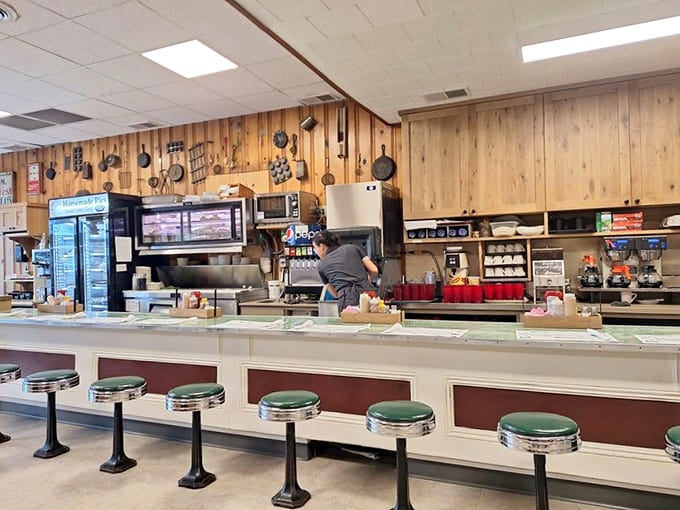 Classic diner stools and wood paneling create the kind of atmosphere where time slows down and appetites wake up.