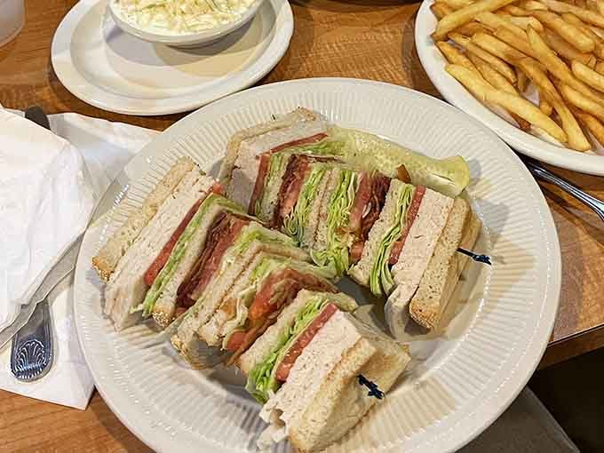The club sandwich stacked high enough to require a game plan, because sometimes lunch needs to be a full contact sport.