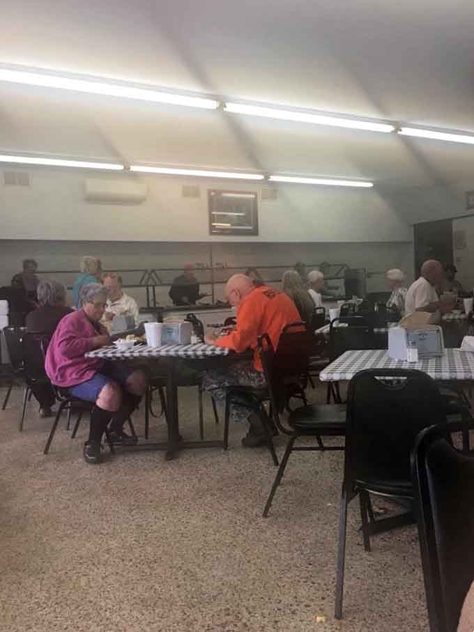 Folks enjoying their meals at checkered tables, living their best buffet life one plate at a time.