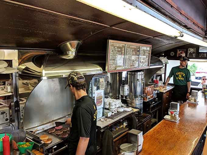 The kitchen where magic happens on a griddle older than most customers, proving experience beats fancy equipment every time.