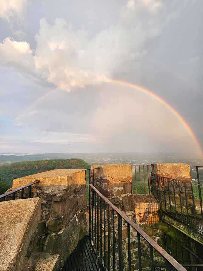 After the storm, a rainbow arcs over the observation deck, nature's own reward for patient visitors.