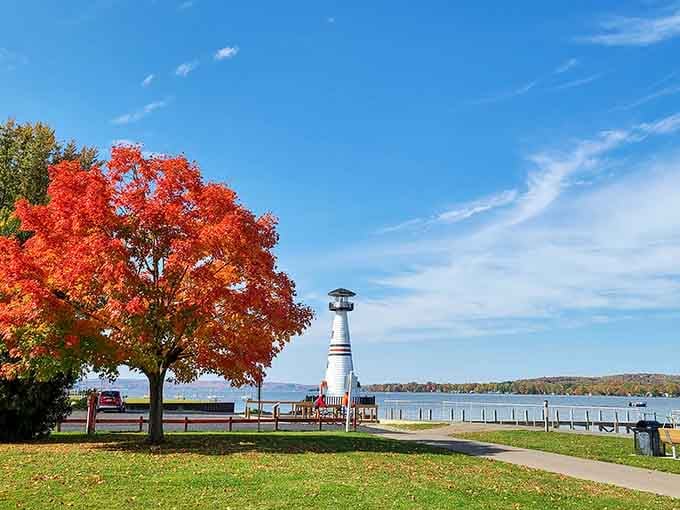 Fall foliage frames Celoron Lighthouse on Chautauqua Lake, where fiery maples compete with blue skies for the title of most spectacular natural show.