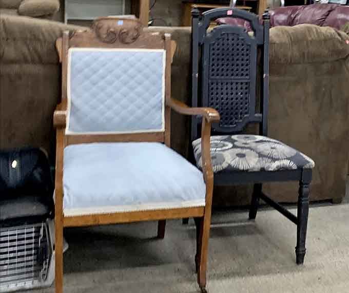 Chair companions waiting for their next conversation. The elegant white one looks ready for a drawing room, while its darker neighbor could tell tales of family dinners.