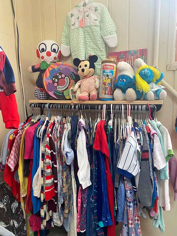 Mickey Mouse and Smurfs sharing shelf space with baby clothes, creating the most adorable nostalgia bomb you'll see today.