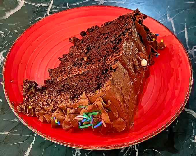 That towering slice of chocolate cake with thick frosting isn't just dessert, it's a commitment to ending your meal on a high note.