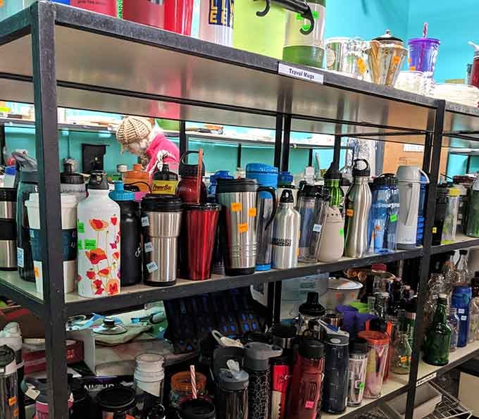 Travel mugs and tumblers line up like caffeinated soldiers, ready to keep your beverages at perfect temperature for pennies.